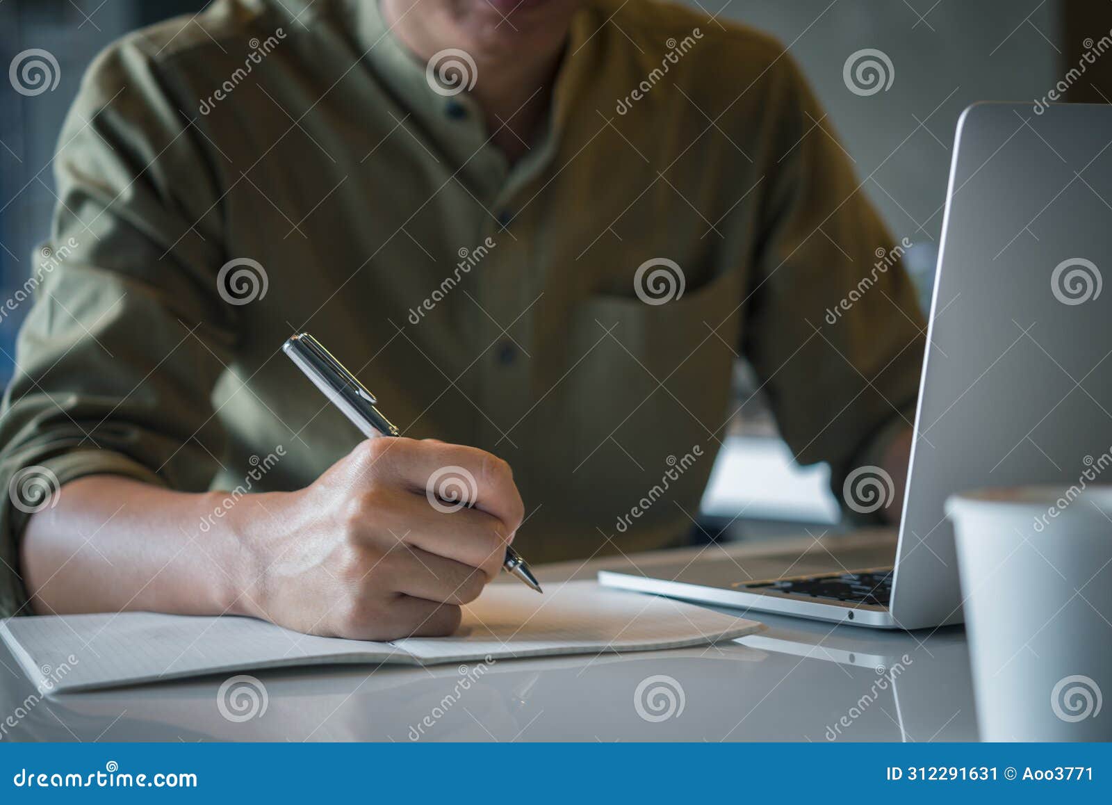 Man Writing Notes with a Laptop at Desk. Online Education and E ...