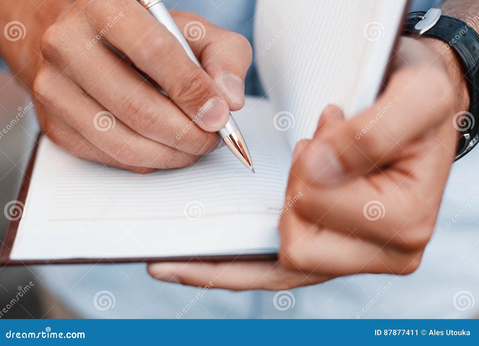 Man Writing Notes in a Notebook. Hand Holding Pen Stock Image - Image ...