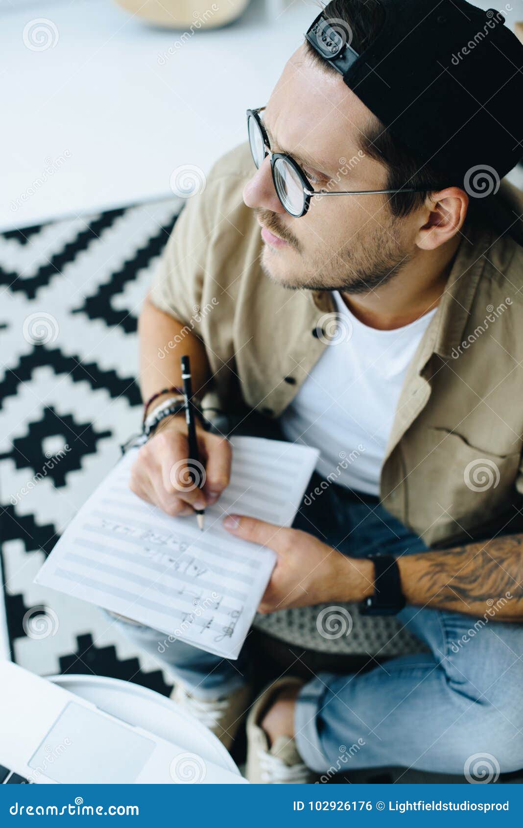 Man writing notes on paper stock photo. Image of young - 102926176