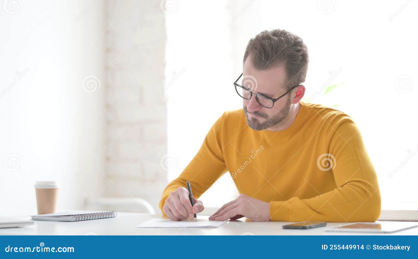 Man Writing on Paper in Office Stock Photo - Image of serious ...