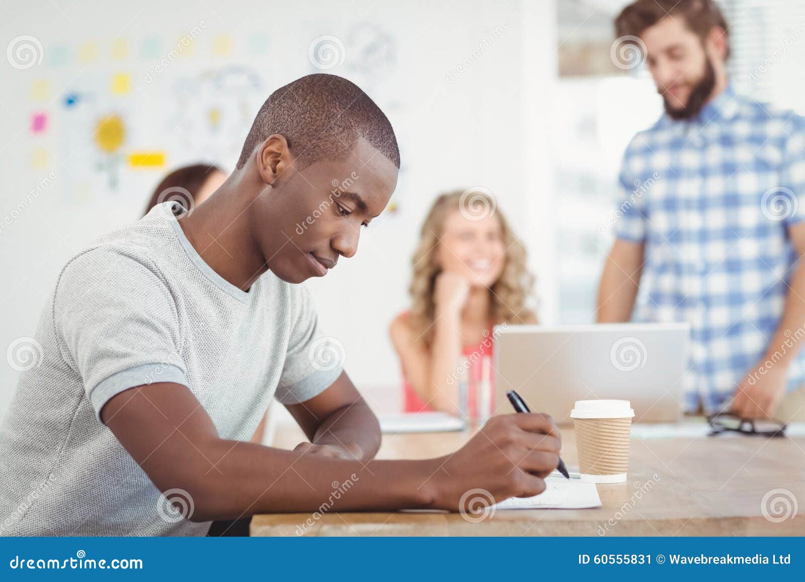 Man Writing on Paper while Sitting at Desk Stock Image - Image of head ...