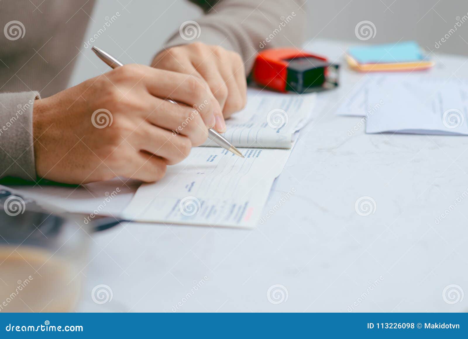 Man Writing a Payment Check at the Table with Calculator and Sta Stock ...