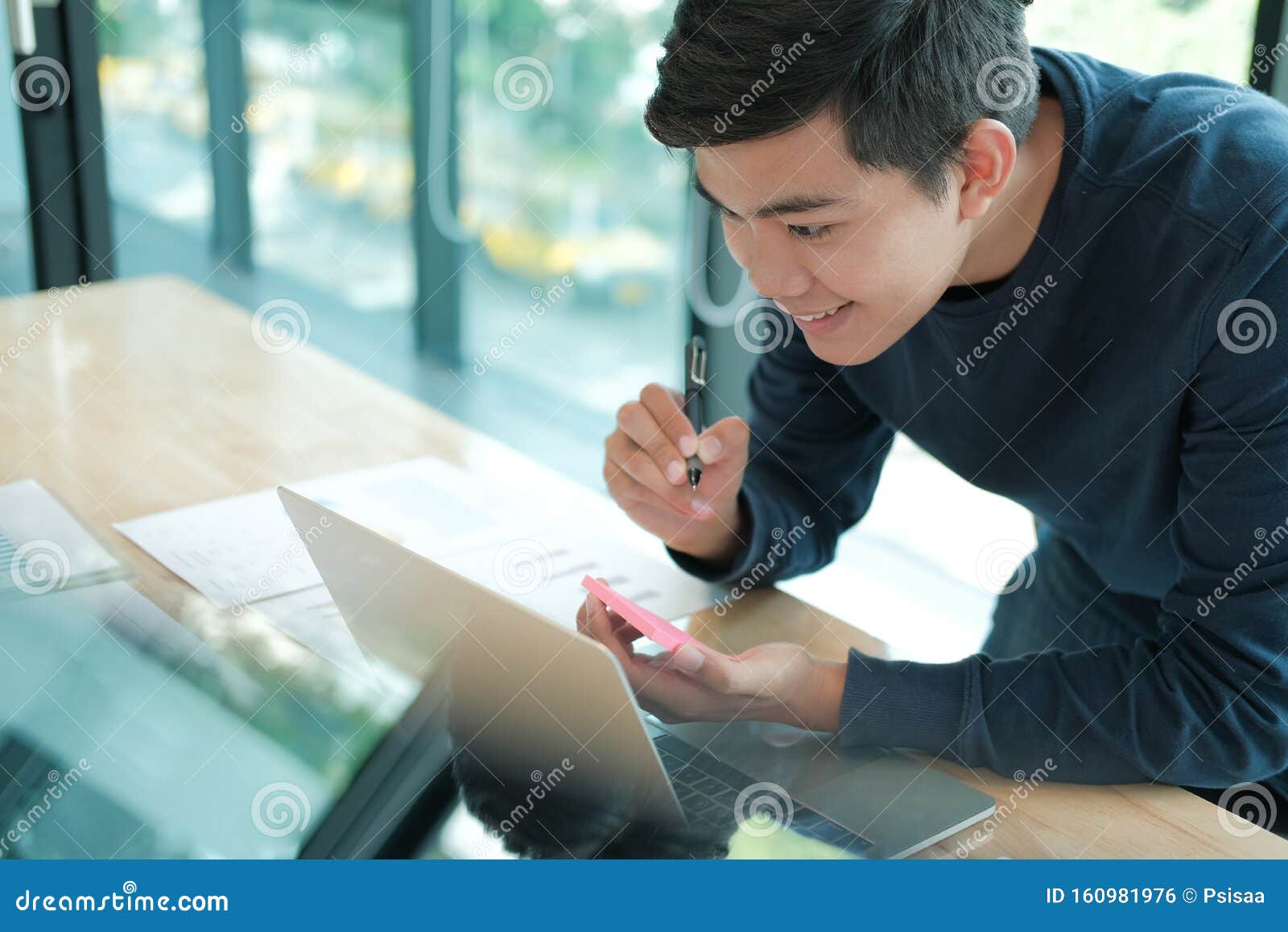 Man Writing Reminder on Sticky Note. Male Freelancer Student Working ...