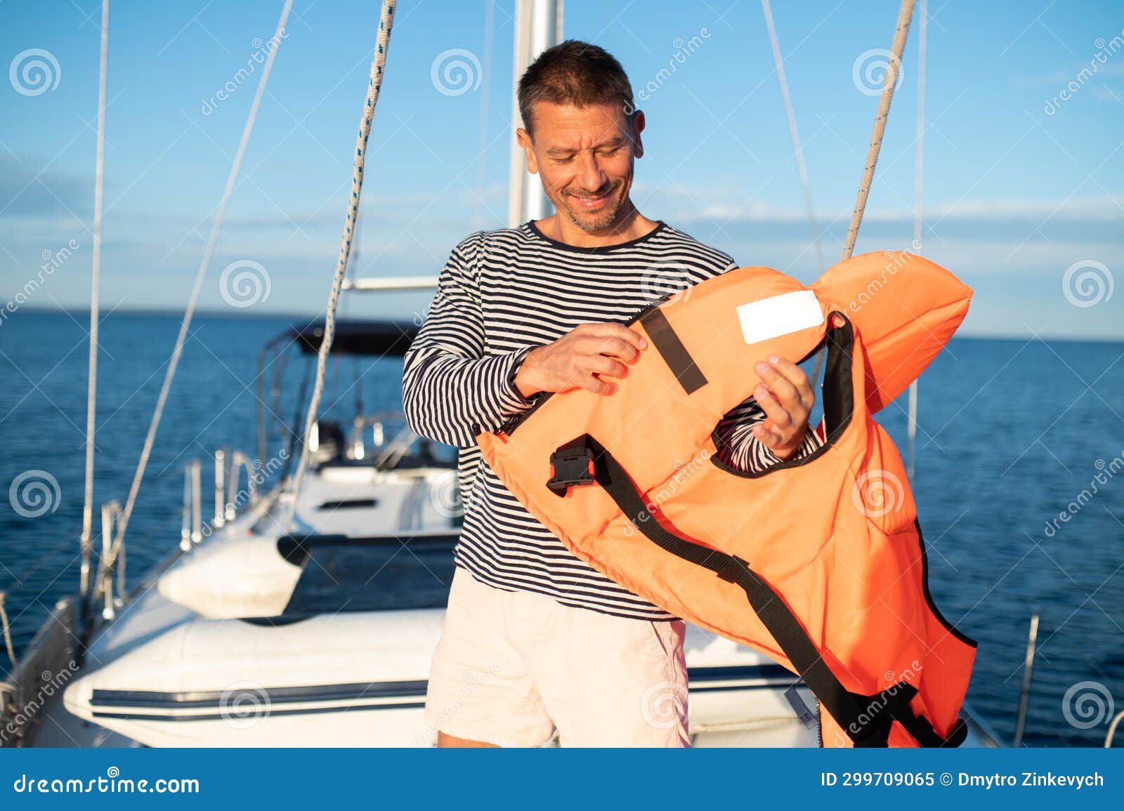 Man on a Yacht Putting on a Life Jacket Stock Image - Image of harmony ...