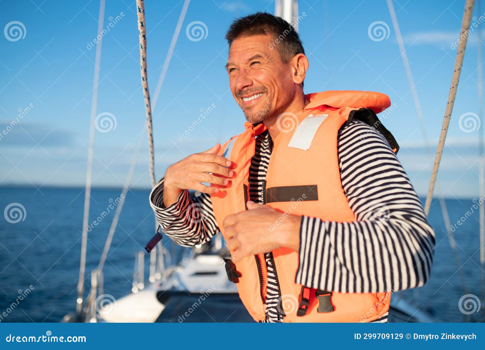 Man on a Yacht Putting on a Life Jacket Stock Image - Image of travel ...