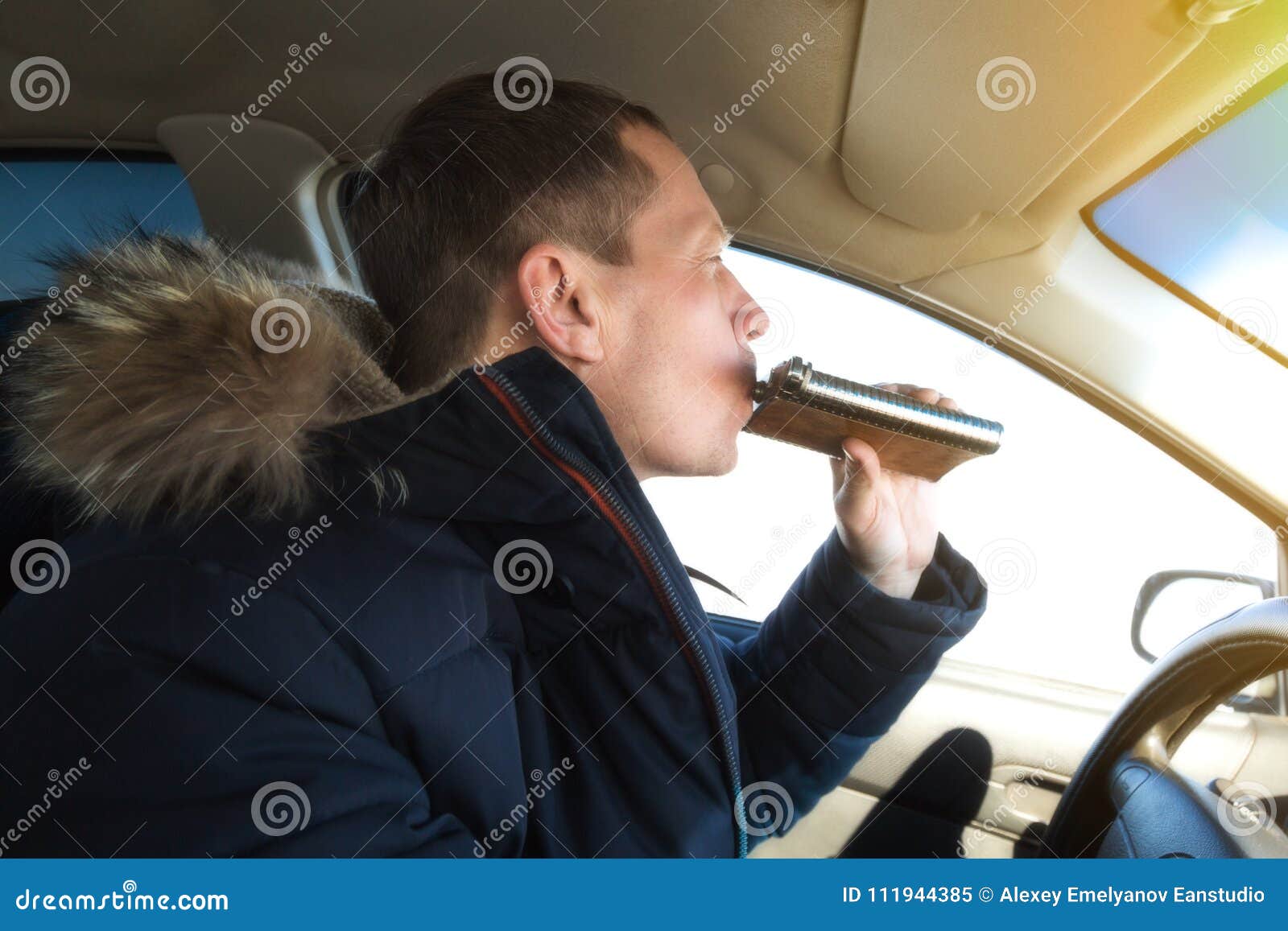 The Driver of an Alcoholic Drinks Cognac while Driving a Car. Stock ...