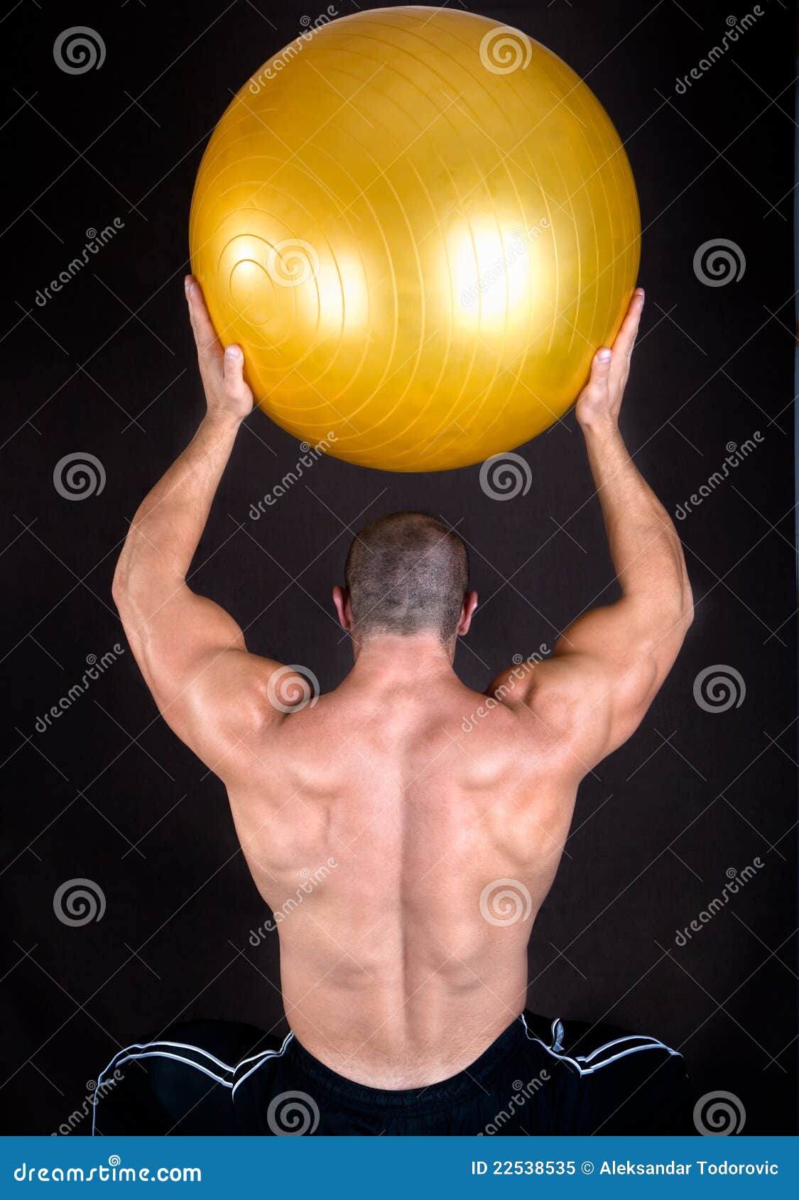 Man with Yellow Ball Posing Artistic Stock Image - Image of scale ...