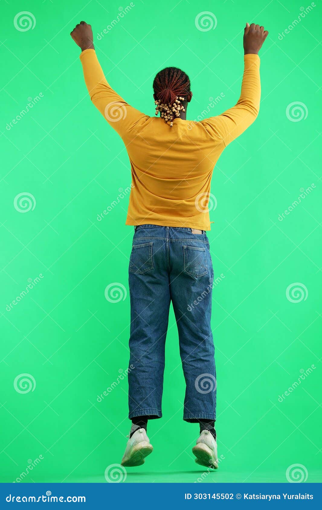 A Man in a Yellow Jacket Jumps on a Green Background, Back View Stock ...