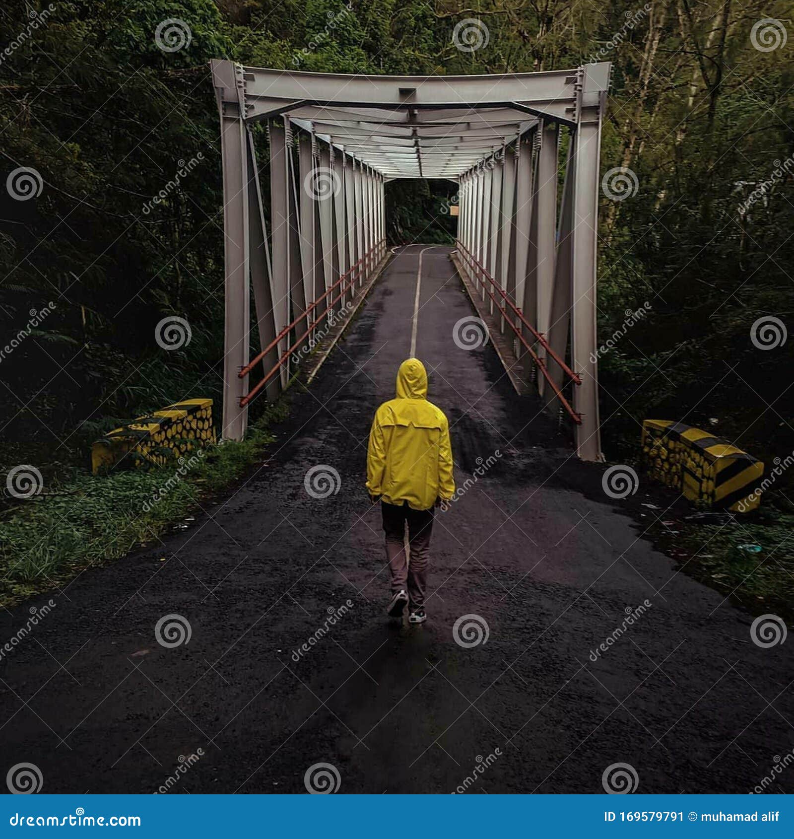 A Man in Yellow is Walking Toward the Bridge Stock Image - Image of ...
