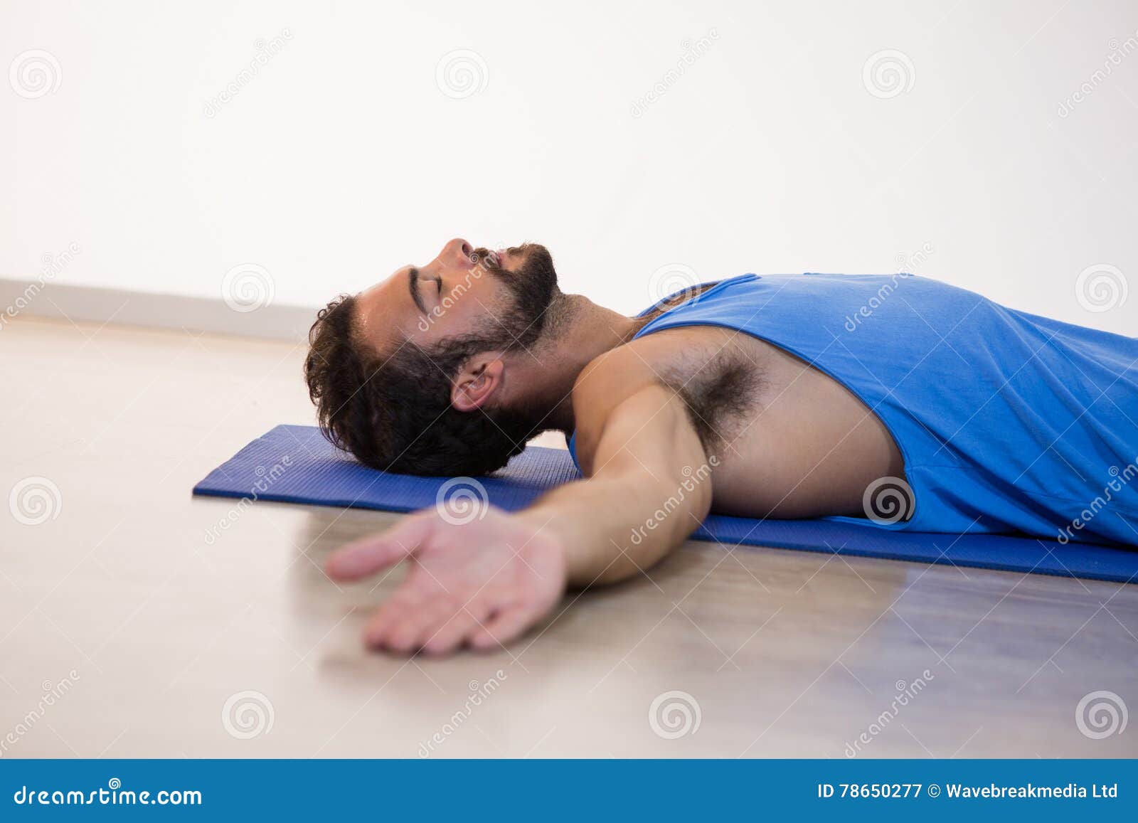 Man in yoga corpse pose stock image. Image of fitness - 78650277