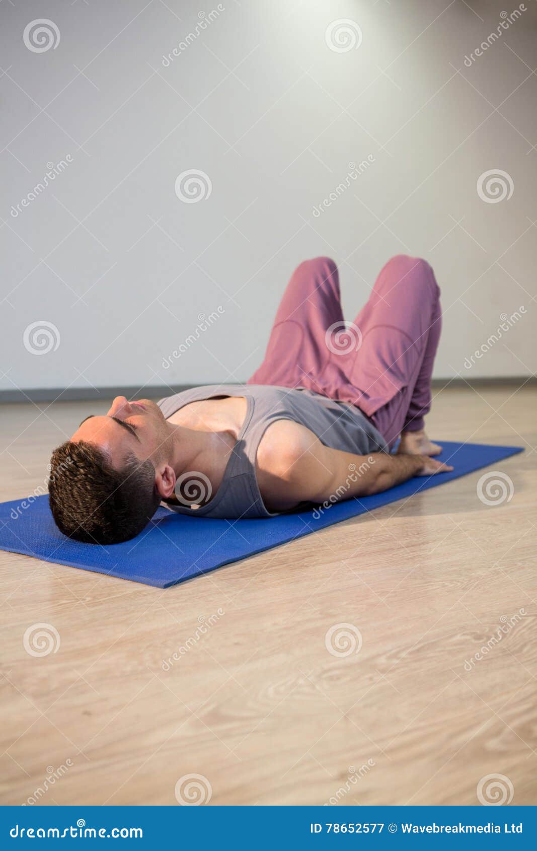 Man in yoga corpse pose stock image. Image of closed - 78652577