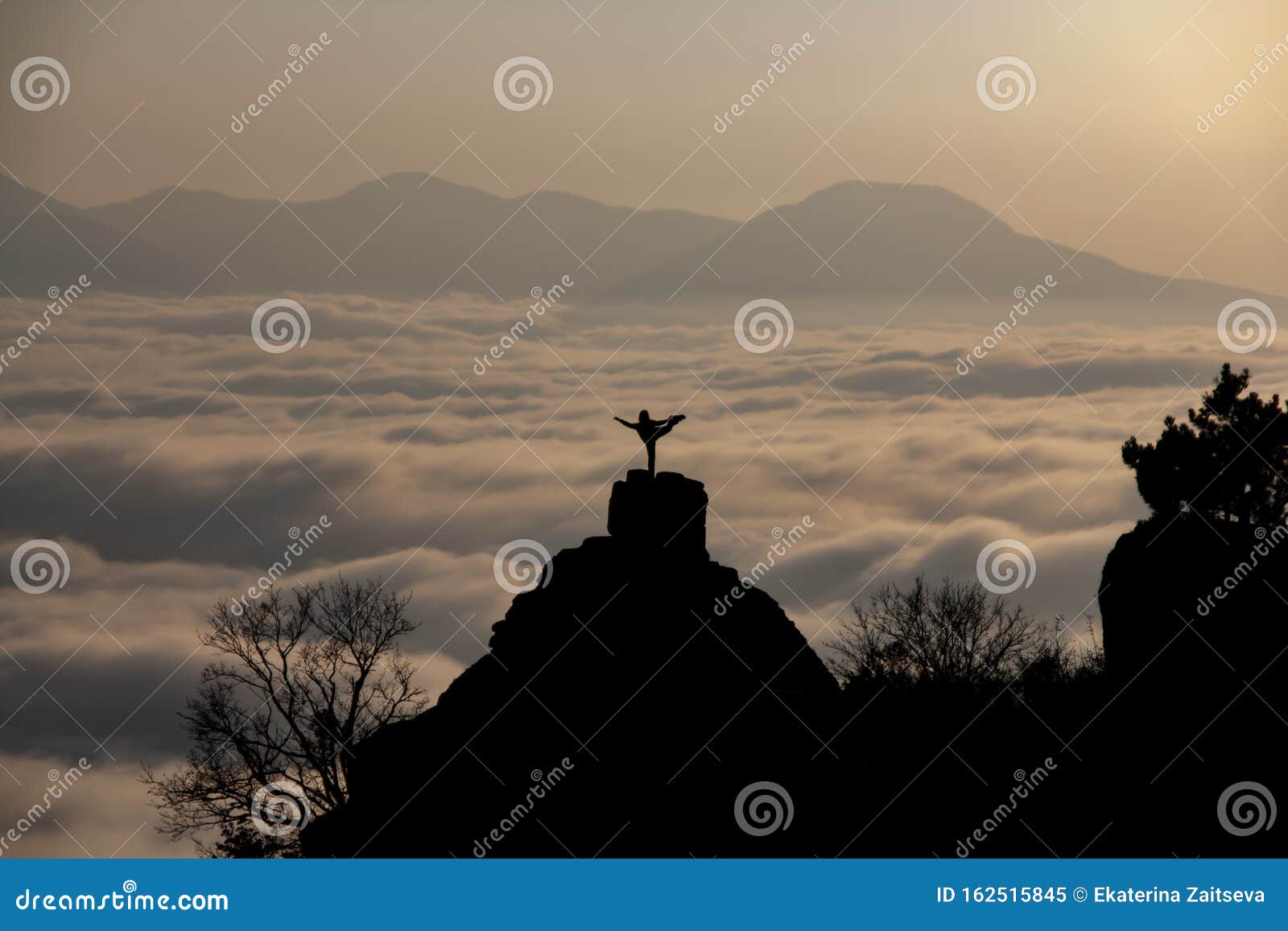 Man in Yoga Pose on Top of a Mountain Above the Clouds Stock Image ...