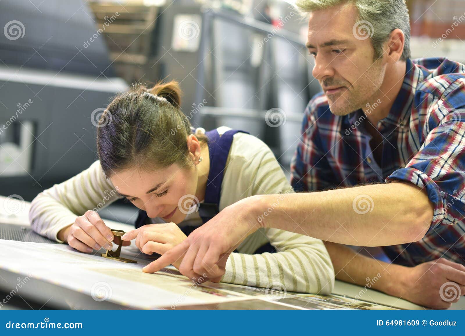 Man and Young Apprentice Checking on Print Quality Stock Image - Image ...