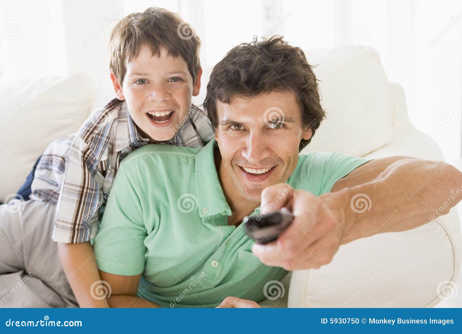 Man and Young Boy with Remote Control Stock Photo - Image of camera ...