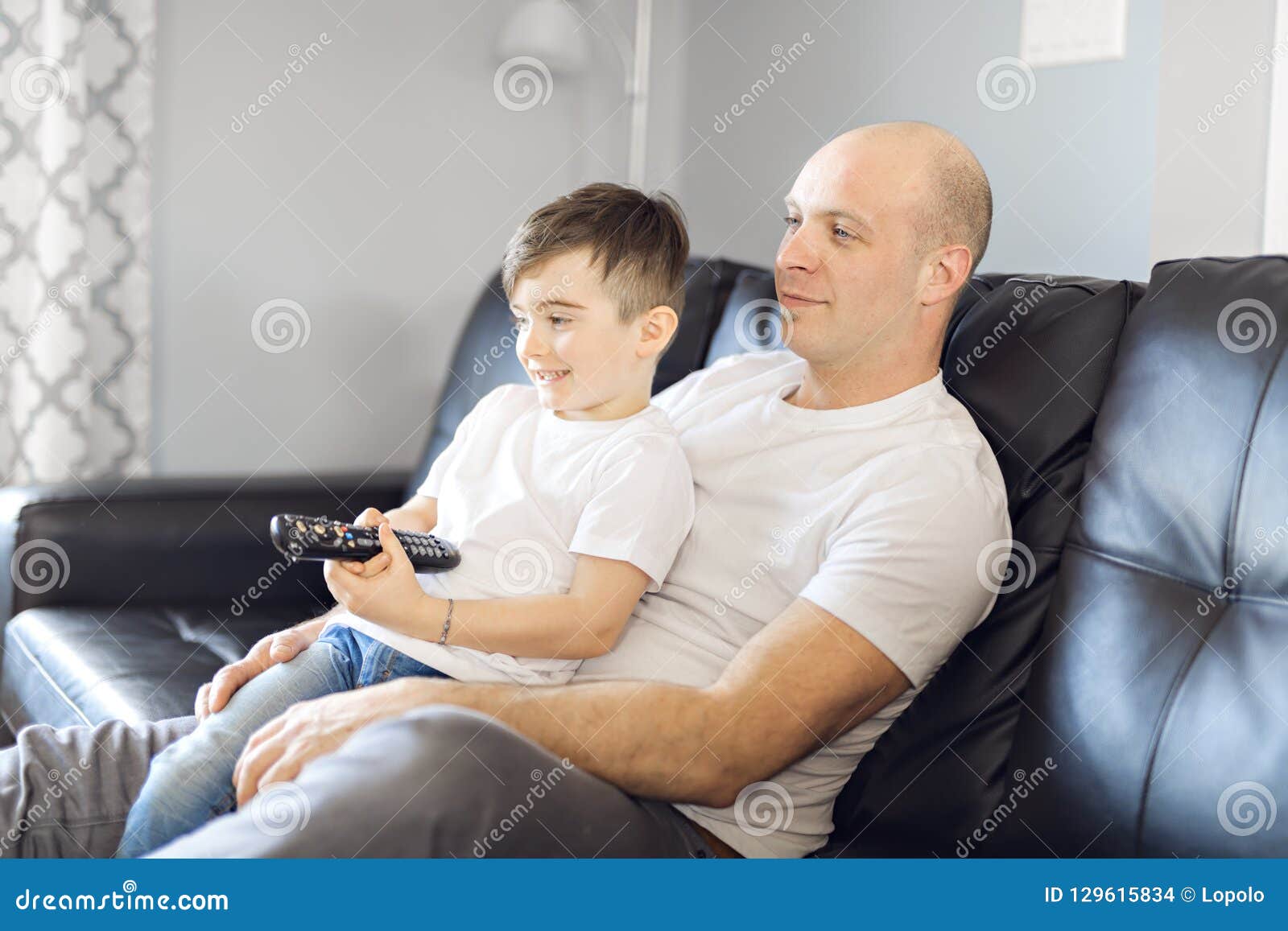 Man and Young Boy with Remote Control Tv Stock Photo - Image of ...