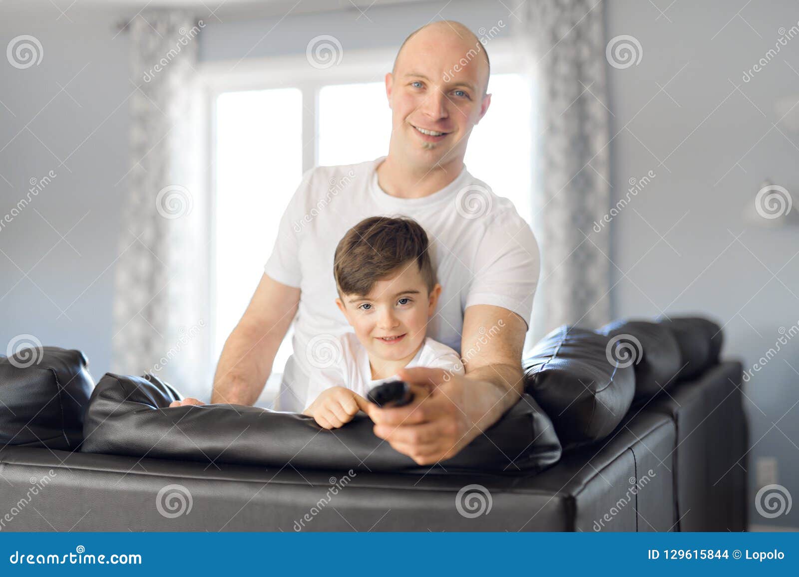 Man and Young Boy with Remote Control Tv Stock Photo - Image of smiling ...