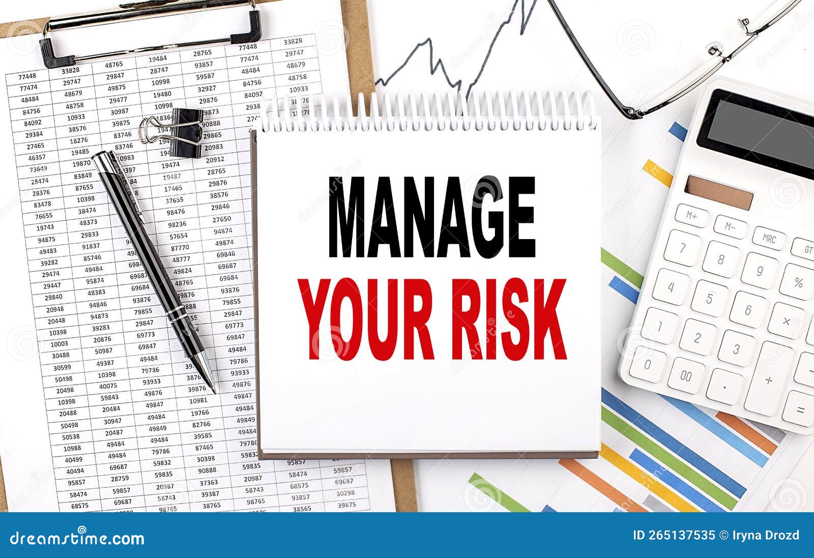MANAGE YOUR RISK Text on Notebook with Chart, Calculator and Pen Stock ...