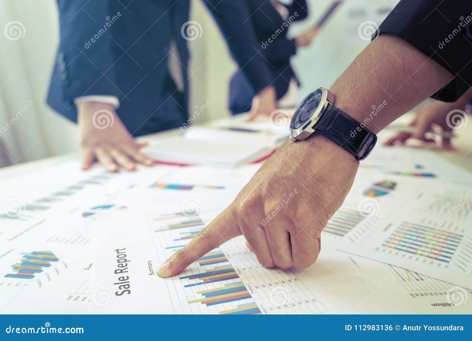 Management Team Meeting Discussing Data Chart on the Table Stock Photo ...