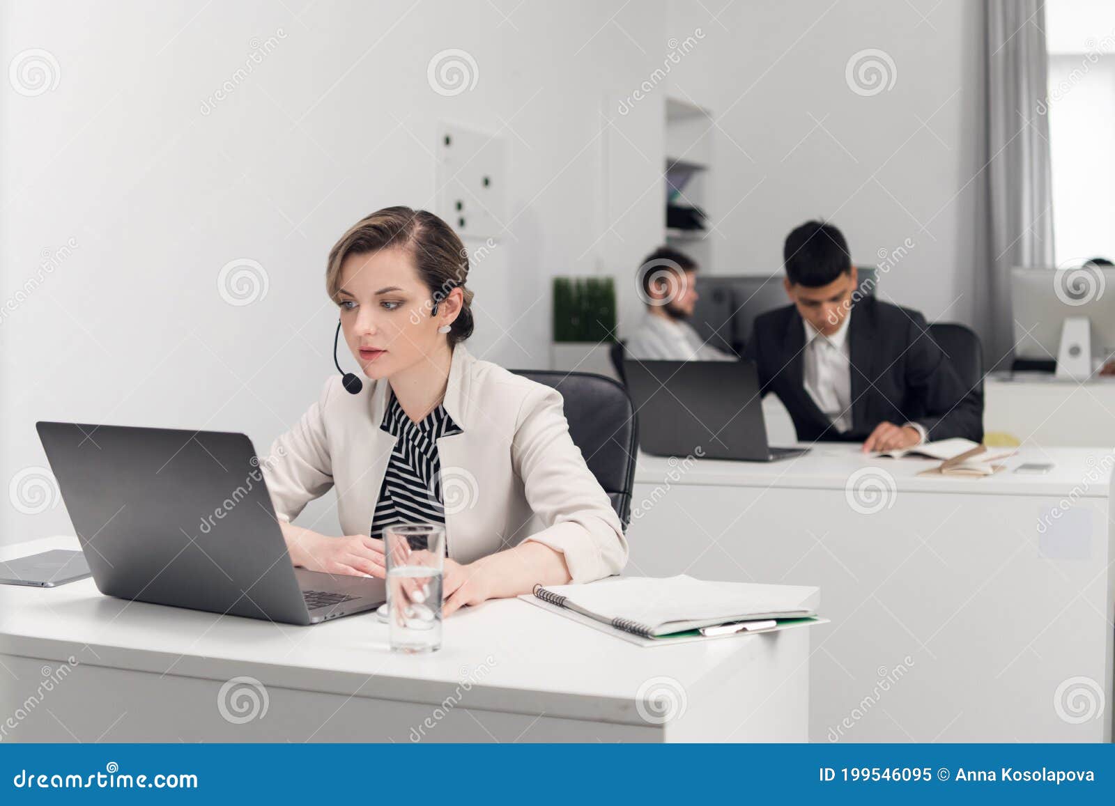 The Manager is Busy with Office Work at a Desk in the Open-space Office ...