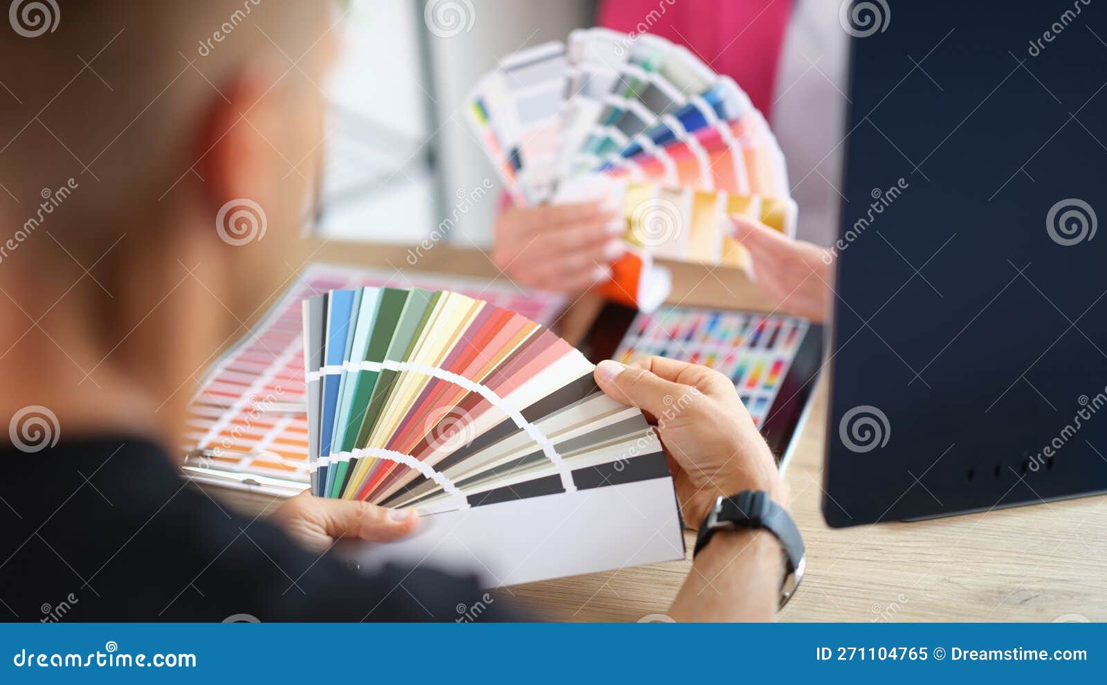 Manager and Client Holding Color Swatch Cards while Sitting at Table in ...