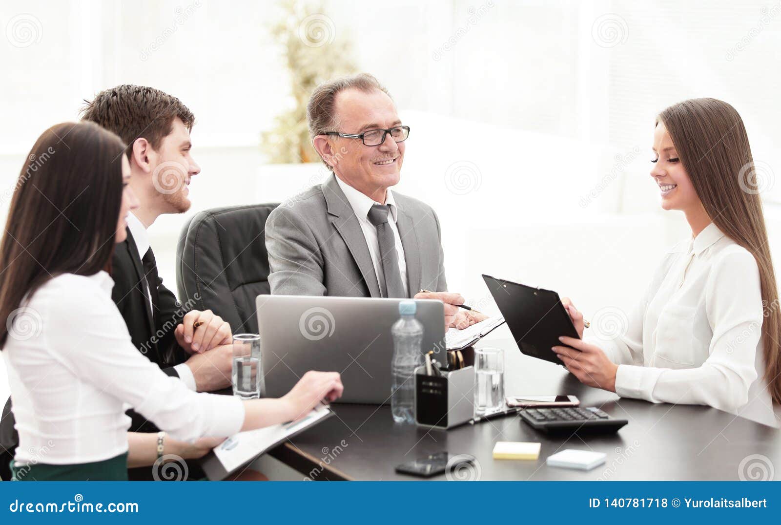 Manager Discussing Work Issues with His Assistants Behind a Desk Stock ...