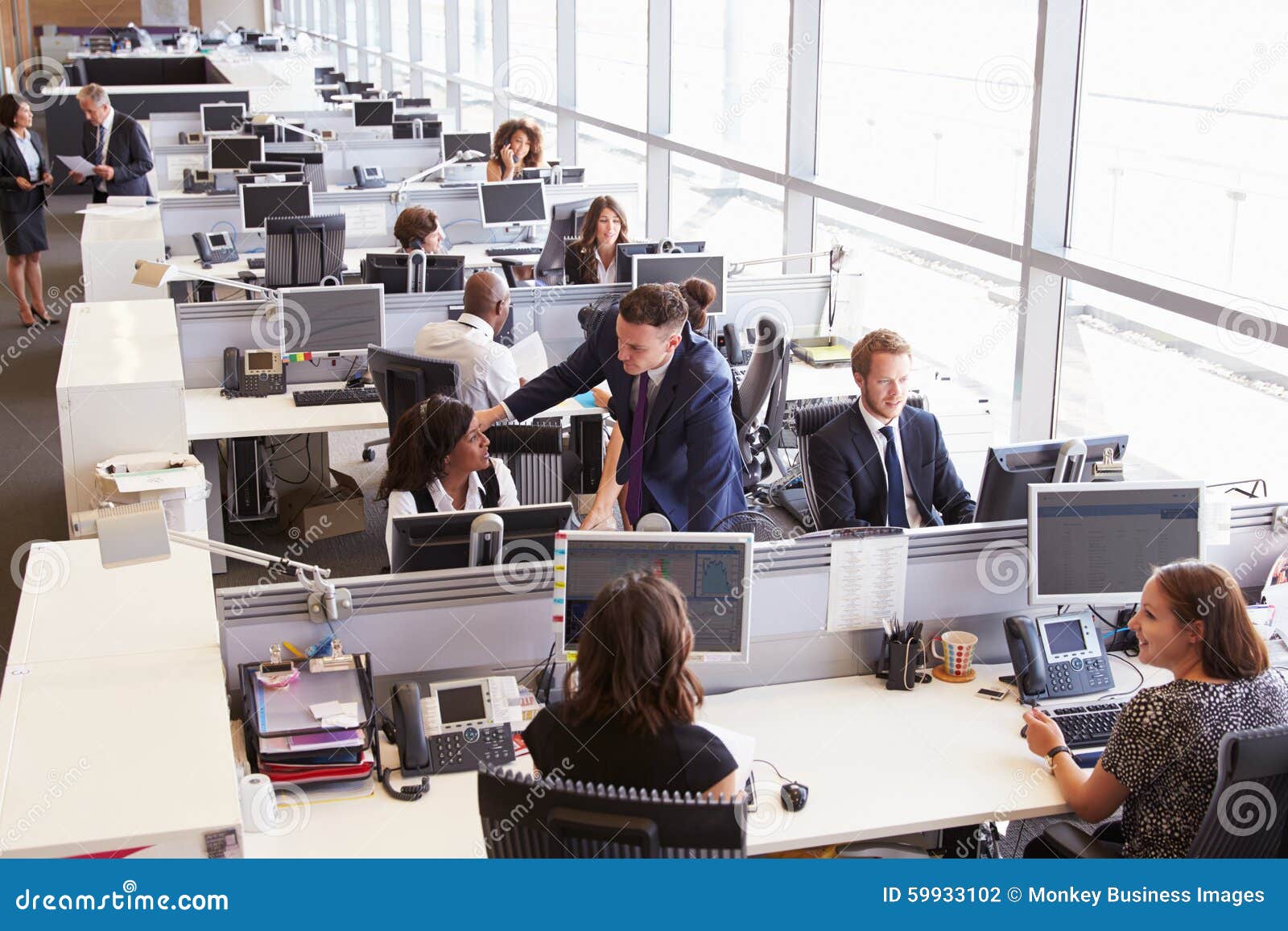 Manager in Discussion with Coworker in an Open Plan Office Stock Photo ...