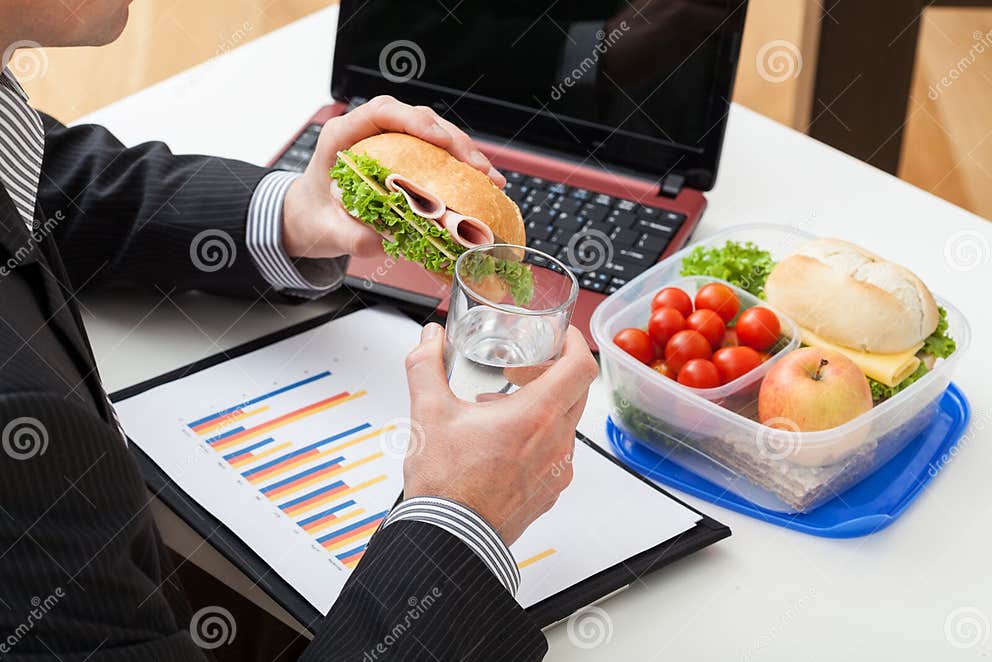 Manager Eating a Sandwich during Work Stock Image - Image of document ...