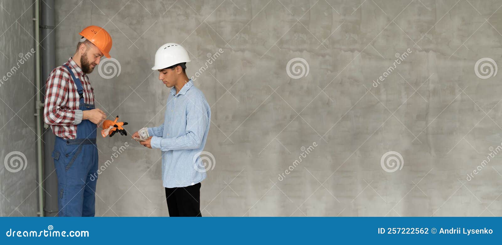 Manager Engineer Giving a Money To Builder for the Work Standing at the Construction Site ...