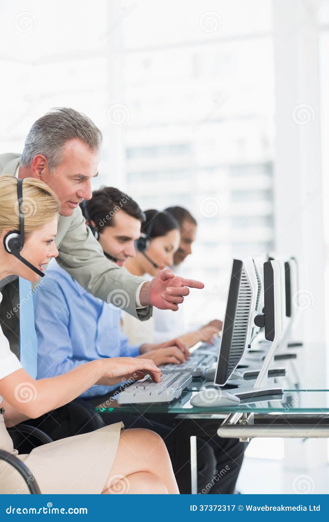 Manager and Executives with Headsets Using Computers Stock Image ...
