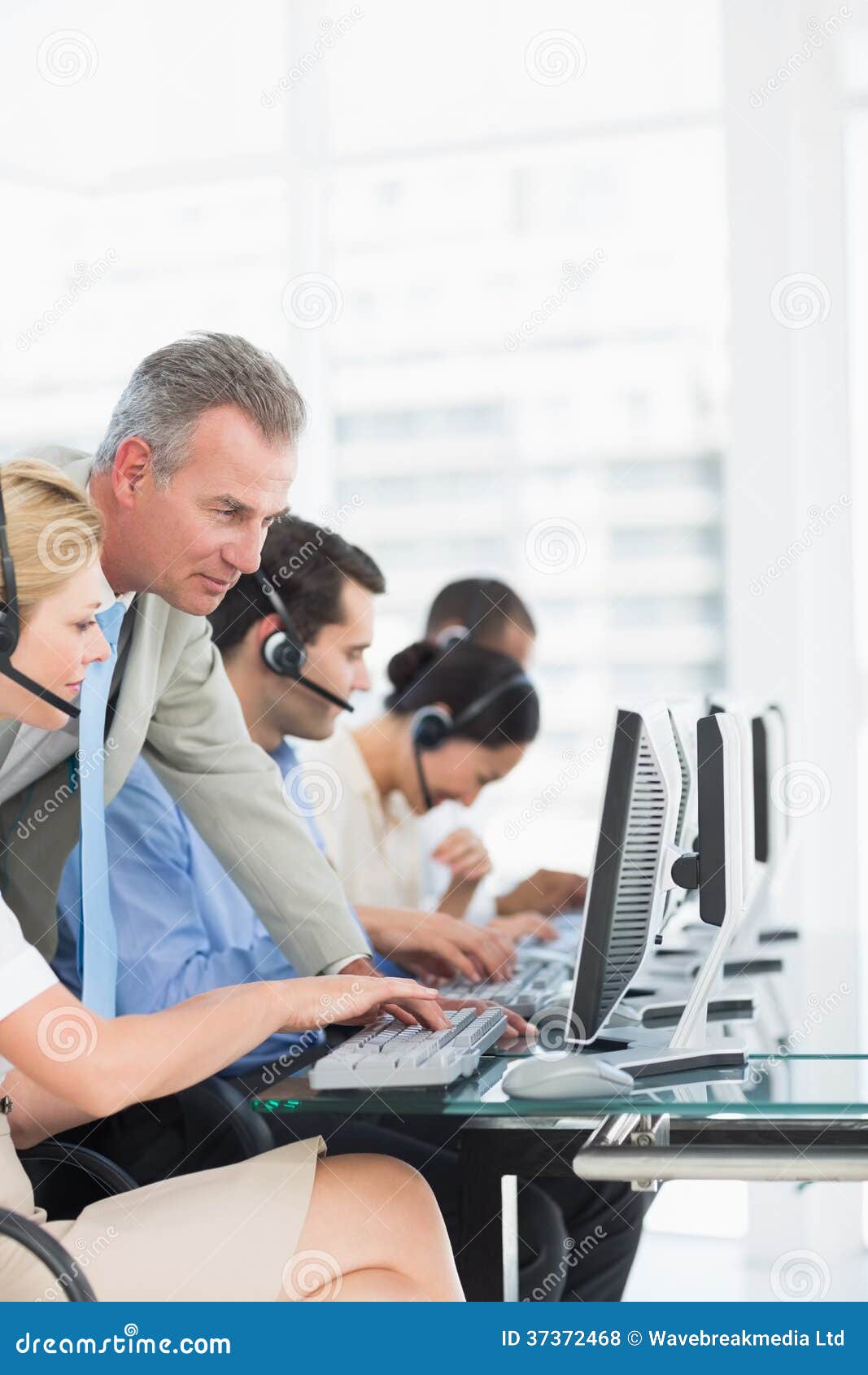 Manager and Executives with Headsets Using Computers Stock Photo ...