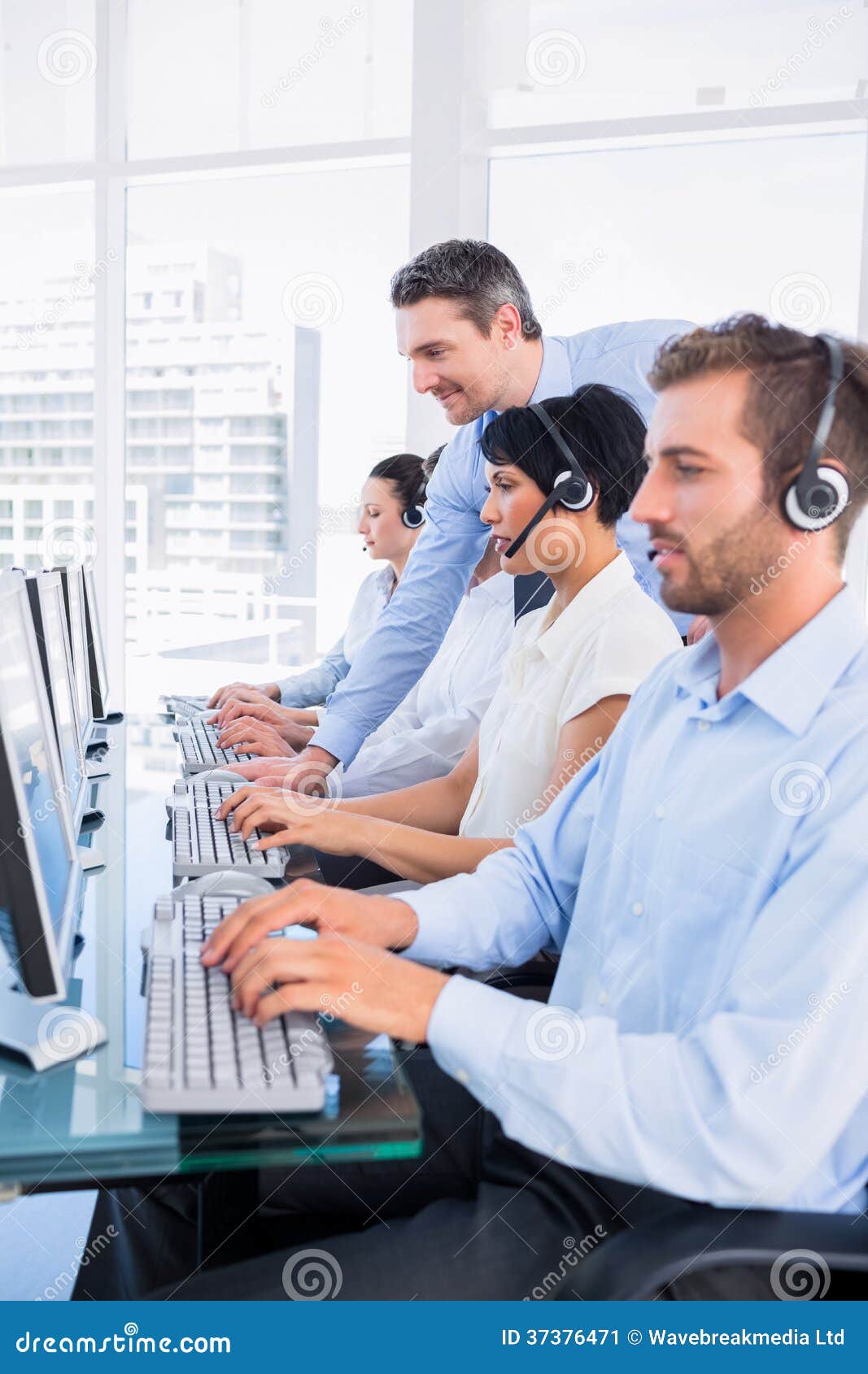 Manager and Executives with Headsets Using Computers Stock Image ...