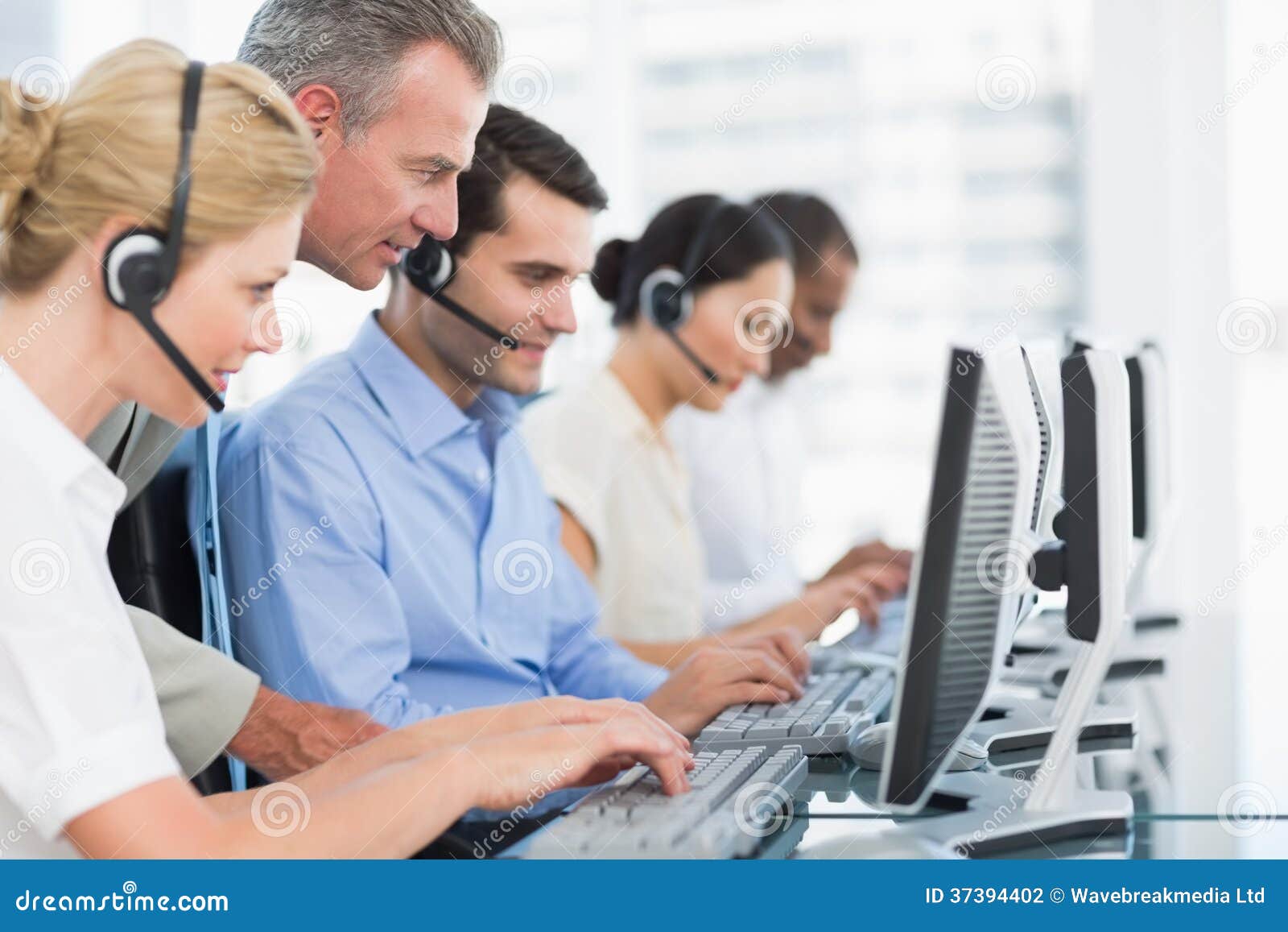 Manager and Executives with Headsets Using Computers Stock Photo ...