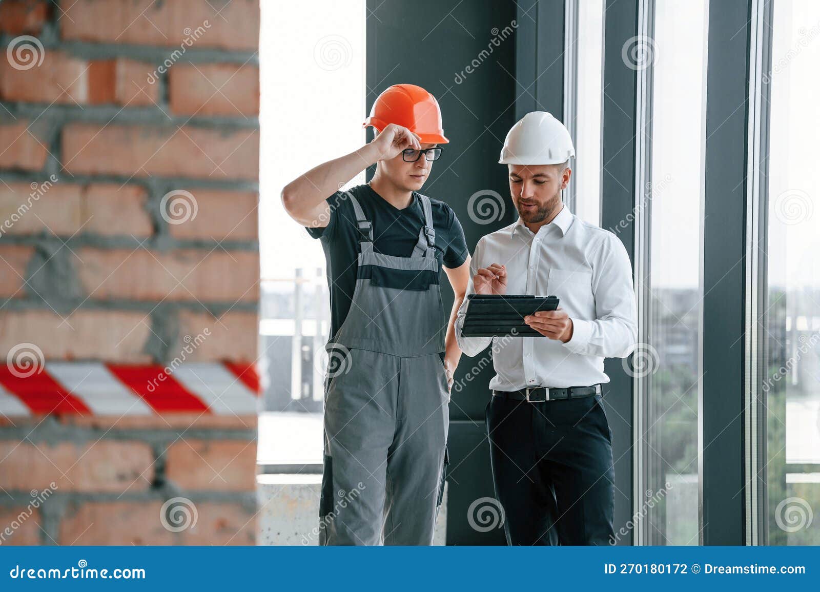 Manager with Foreman are Working on the Construction Site Together ...