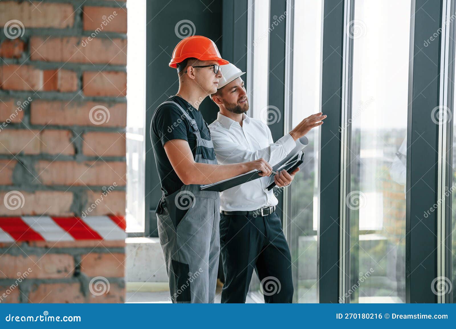 Manager with Foreman are Working on the Construction Site Together ...