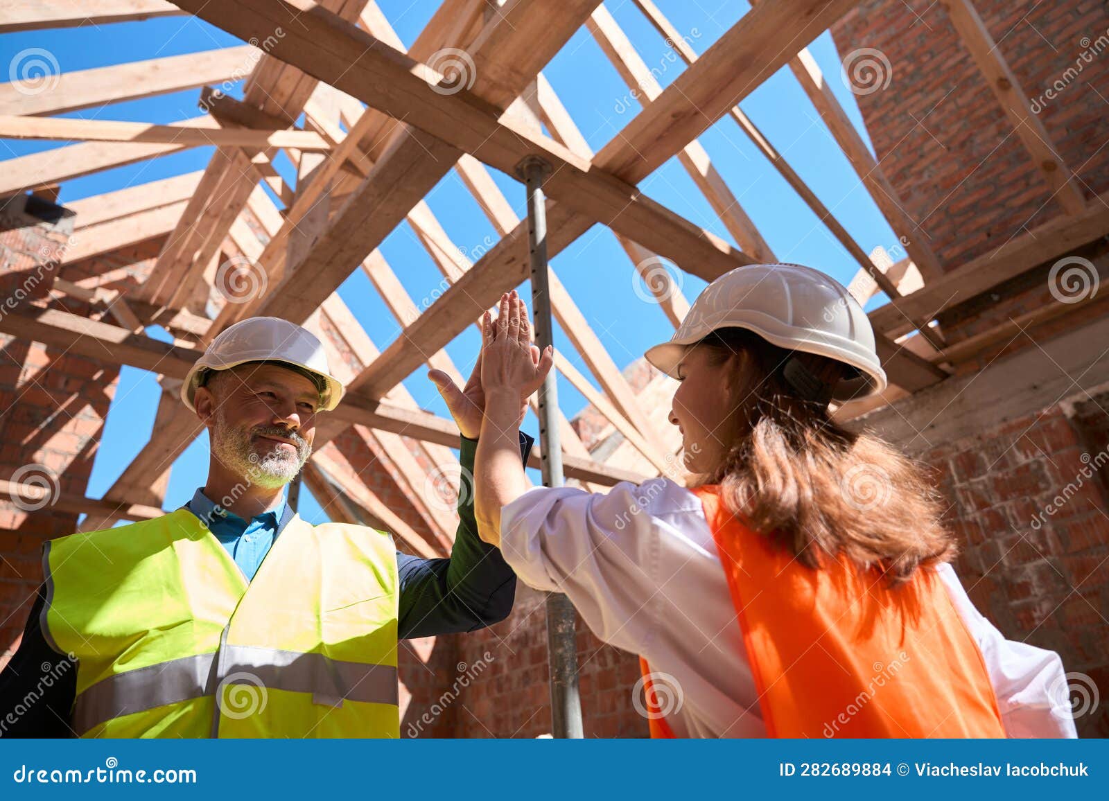 Manager and General Constructor Giving High-five, Finishing Wall Construction Stock Photo ...