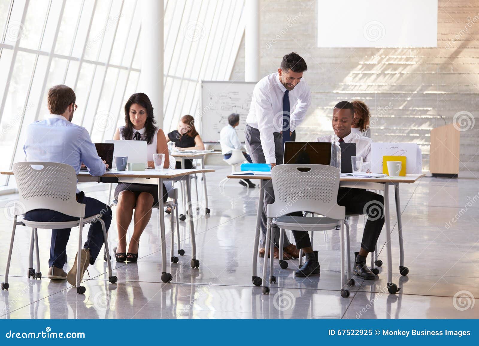Manager Helping Staff in Busy Office Environment Stock Image - Image of ...