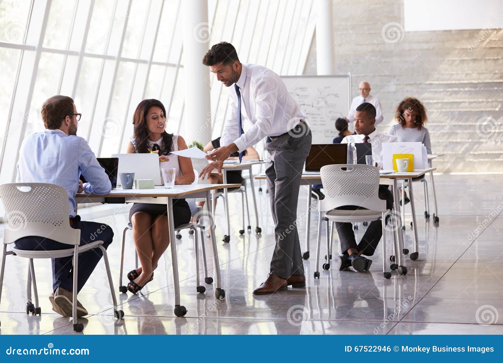 Manager Helping Staff in Busy Office Environment Stock Photo - Image of ...