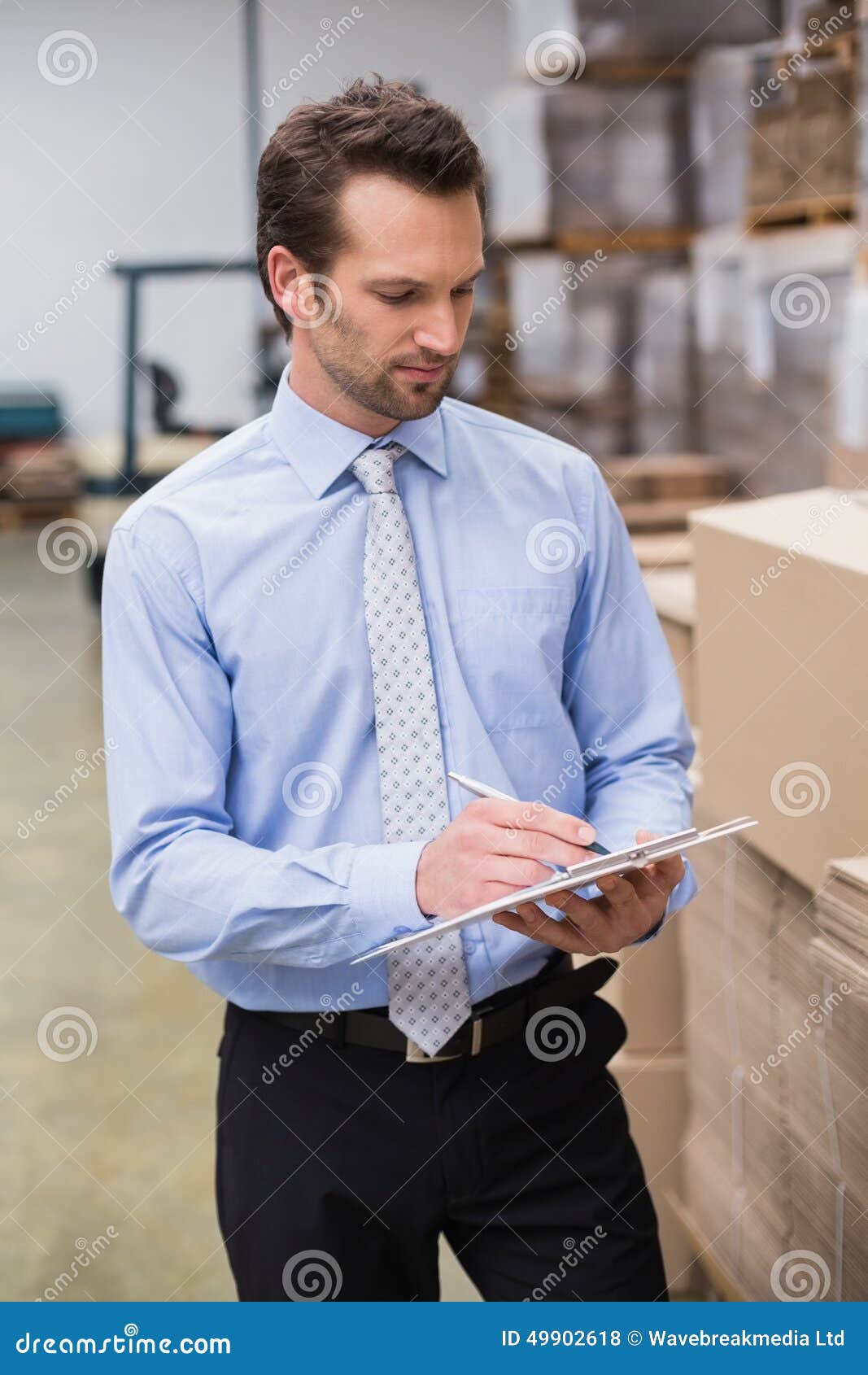 Manager Holding Clipboard in Warehouse Stock Photo - Image of cardboard ...
