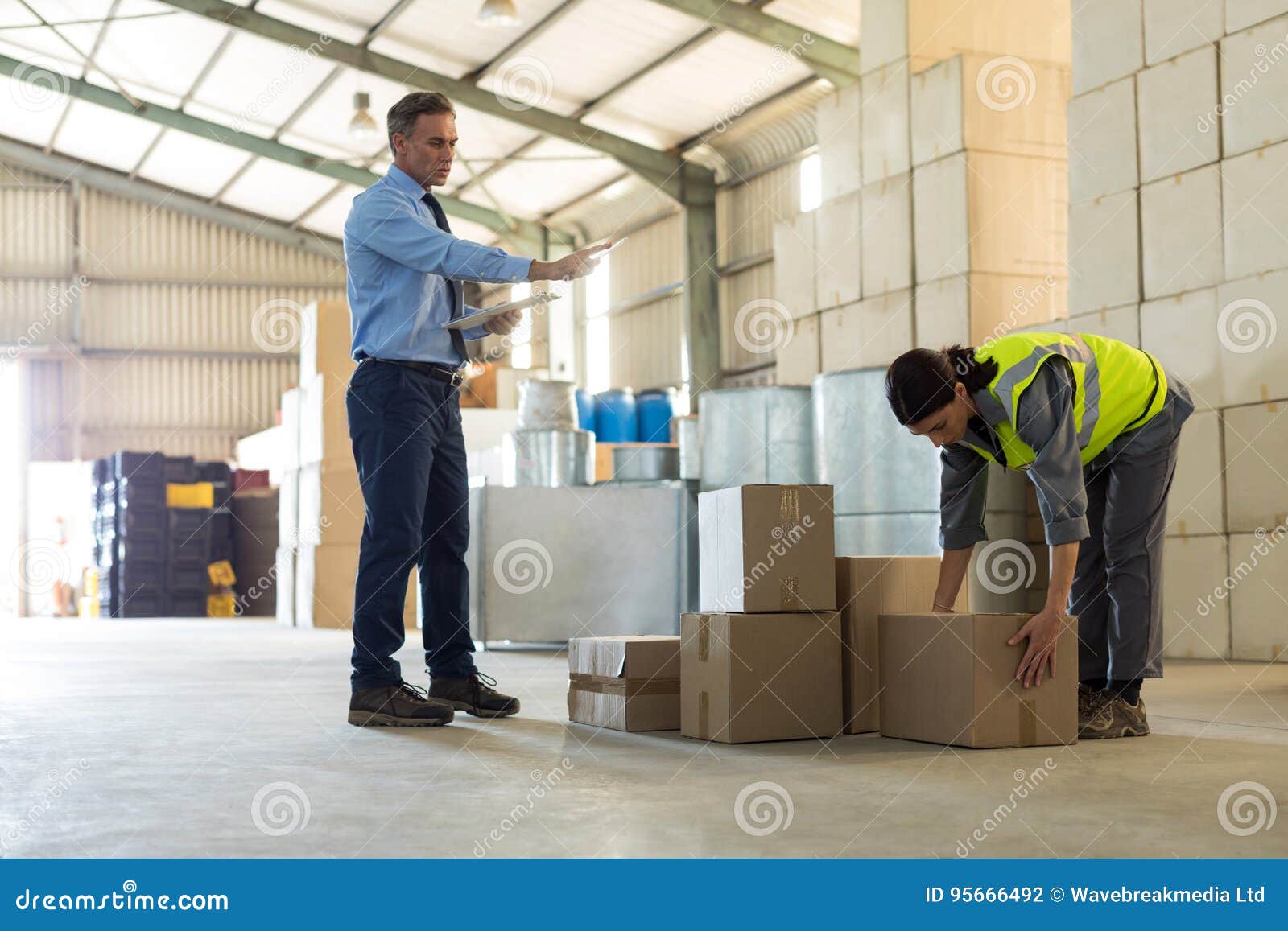 Manager Instructing Female Worker while Working Stock Photo - Image of ...
