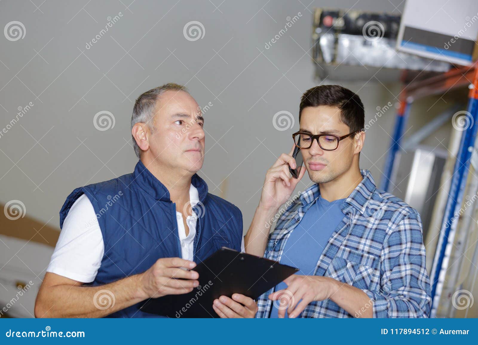Manager and Man Calling on Phone at Workshop Warehouse Stock Photo ...