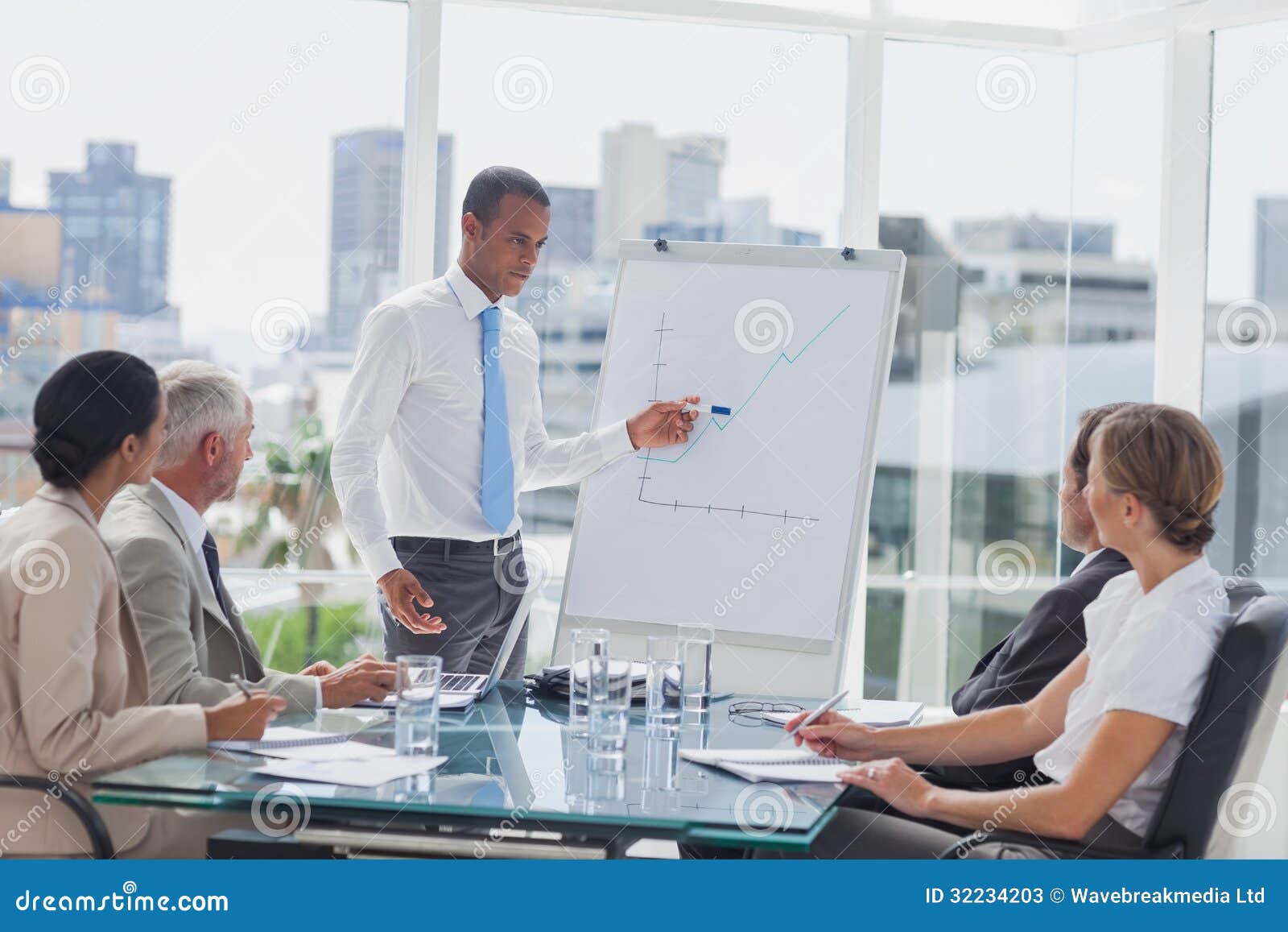 Manager Pointing at a Growing Chart during a Meeting Stock Image ...