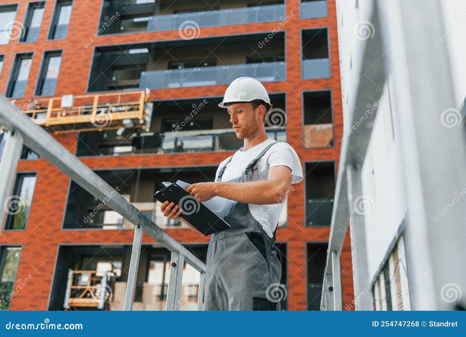 Manager of Project. Young Man Working in Uniform at Construction at ...