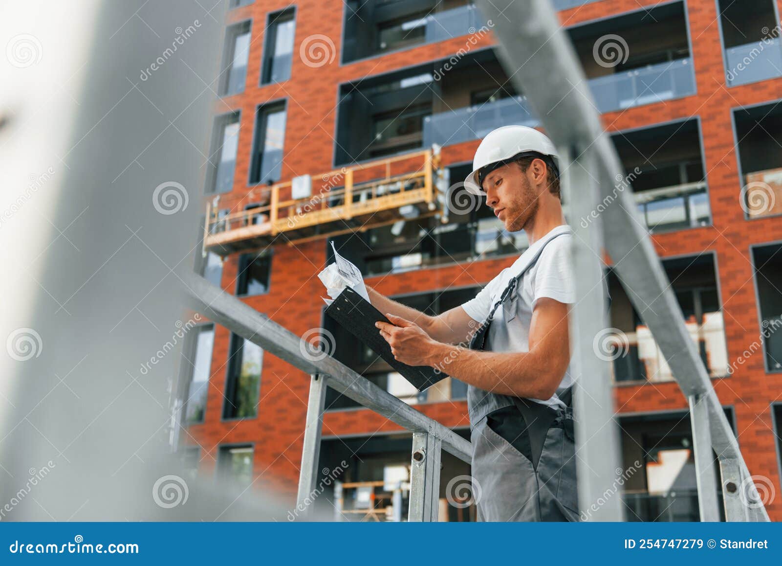 Manager of Project. Young Man Working in Uniform at Construction at ...