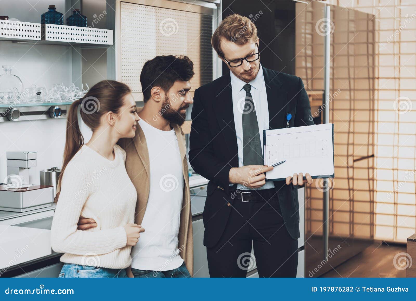 A Salesman in a Suit Shows Buyers the Layout. Stock Photo - Image of ...