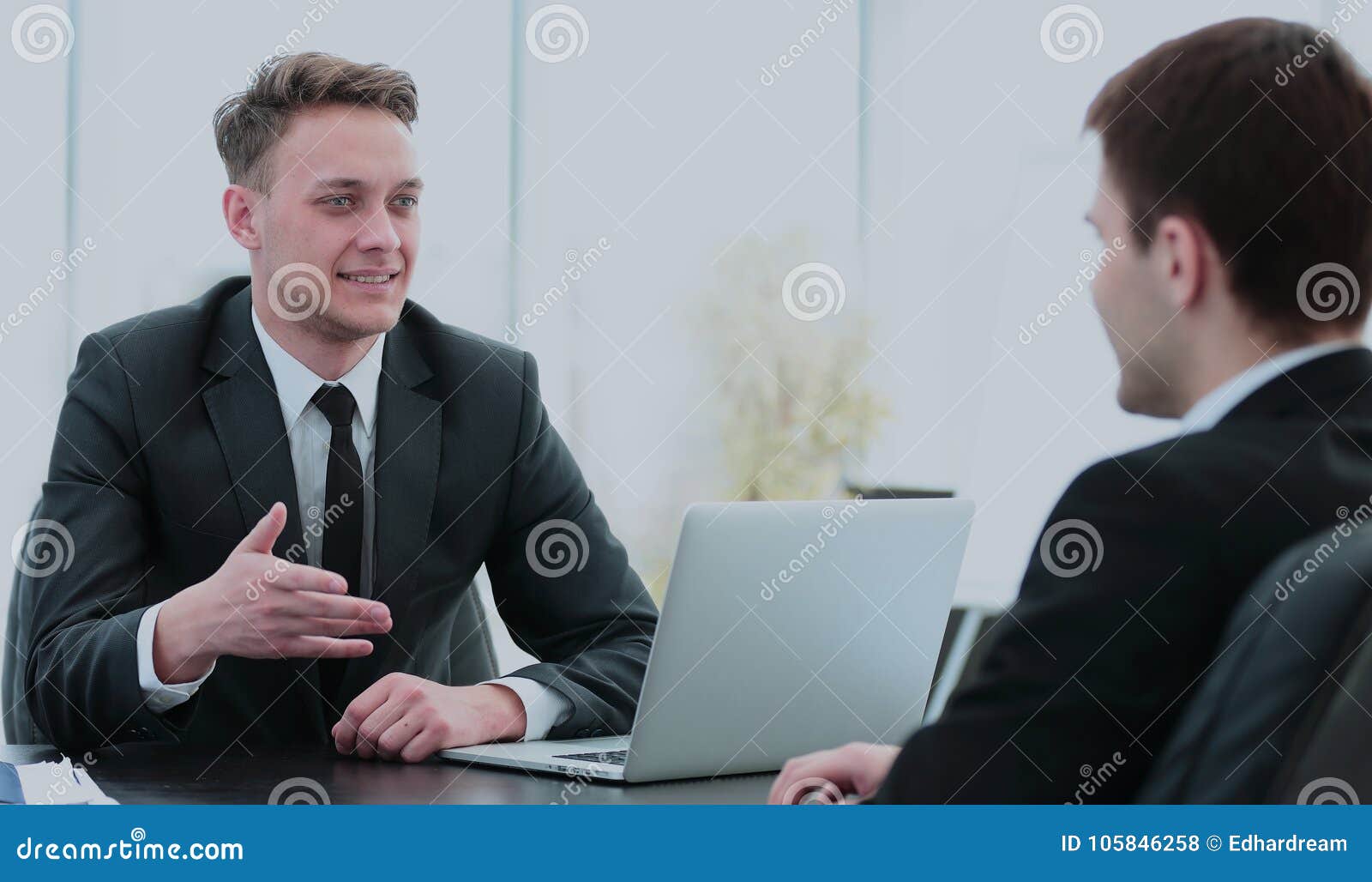 Manager Sits Behind the Desk and Talks To the Client Stock Photo ...