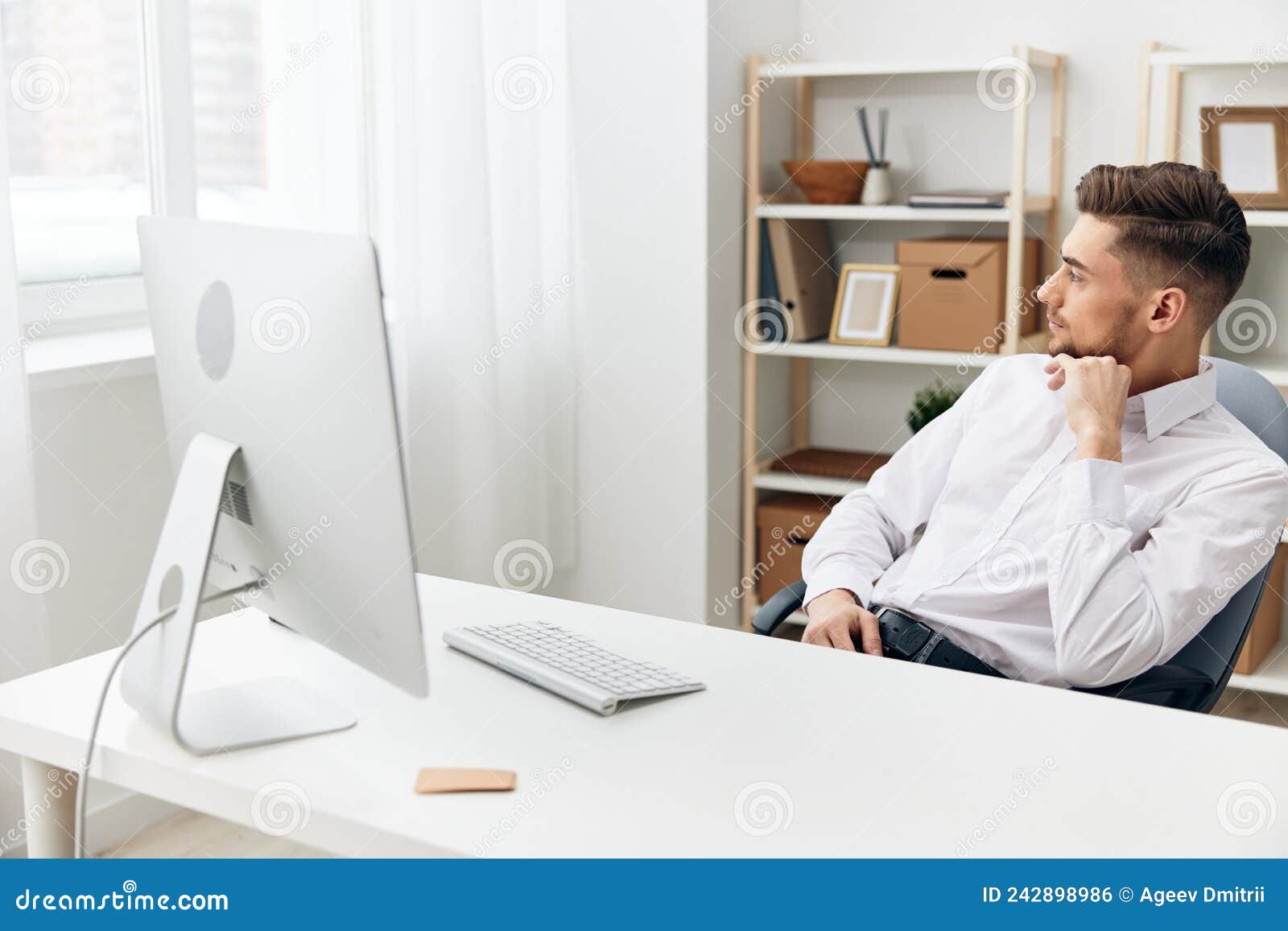 Manager Sitting at a Desk in Front of a Computer with a Keyboard ...