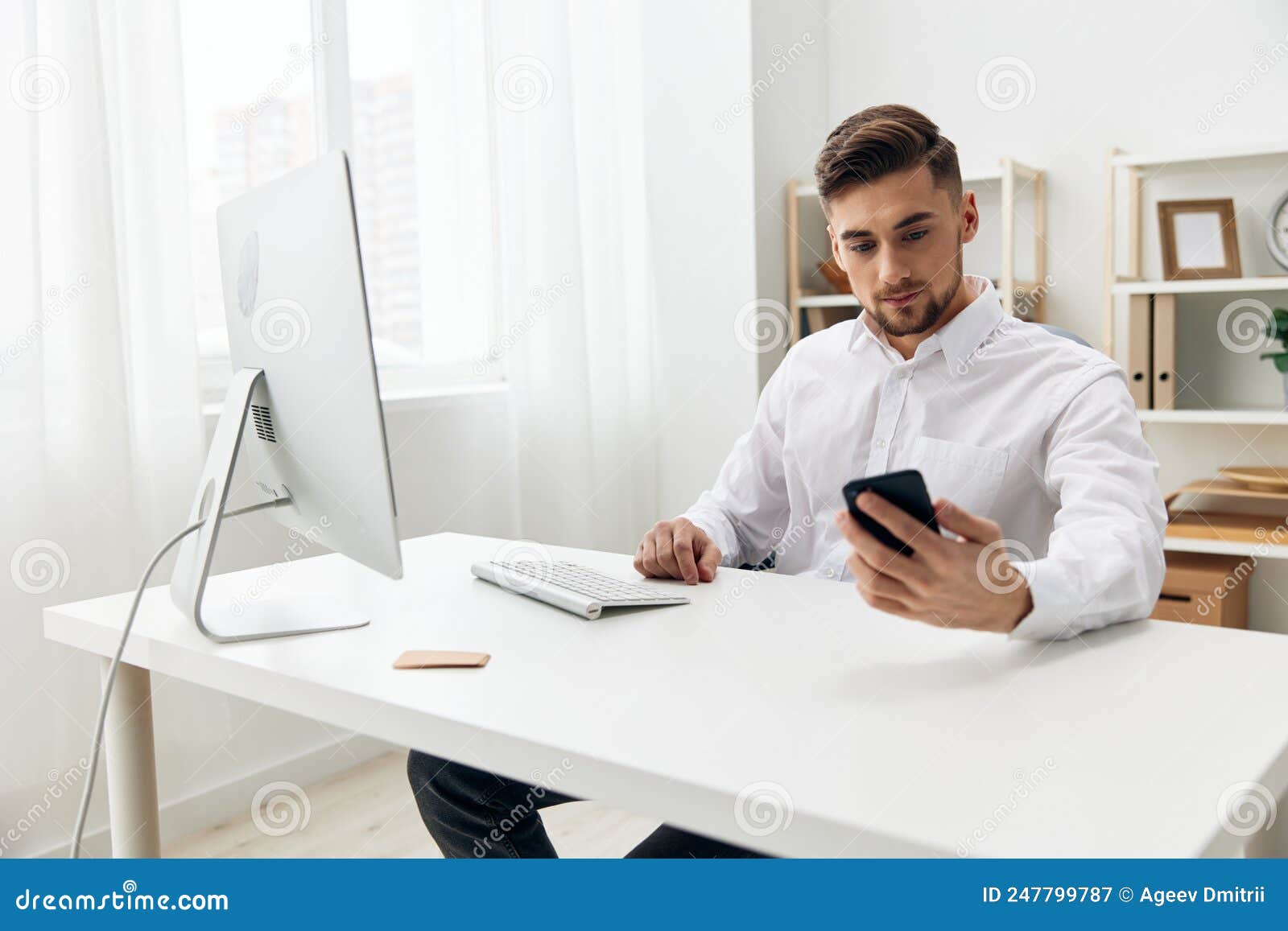 Manager Sitting at a Desk in Front of a Computer with a Keyboard ...