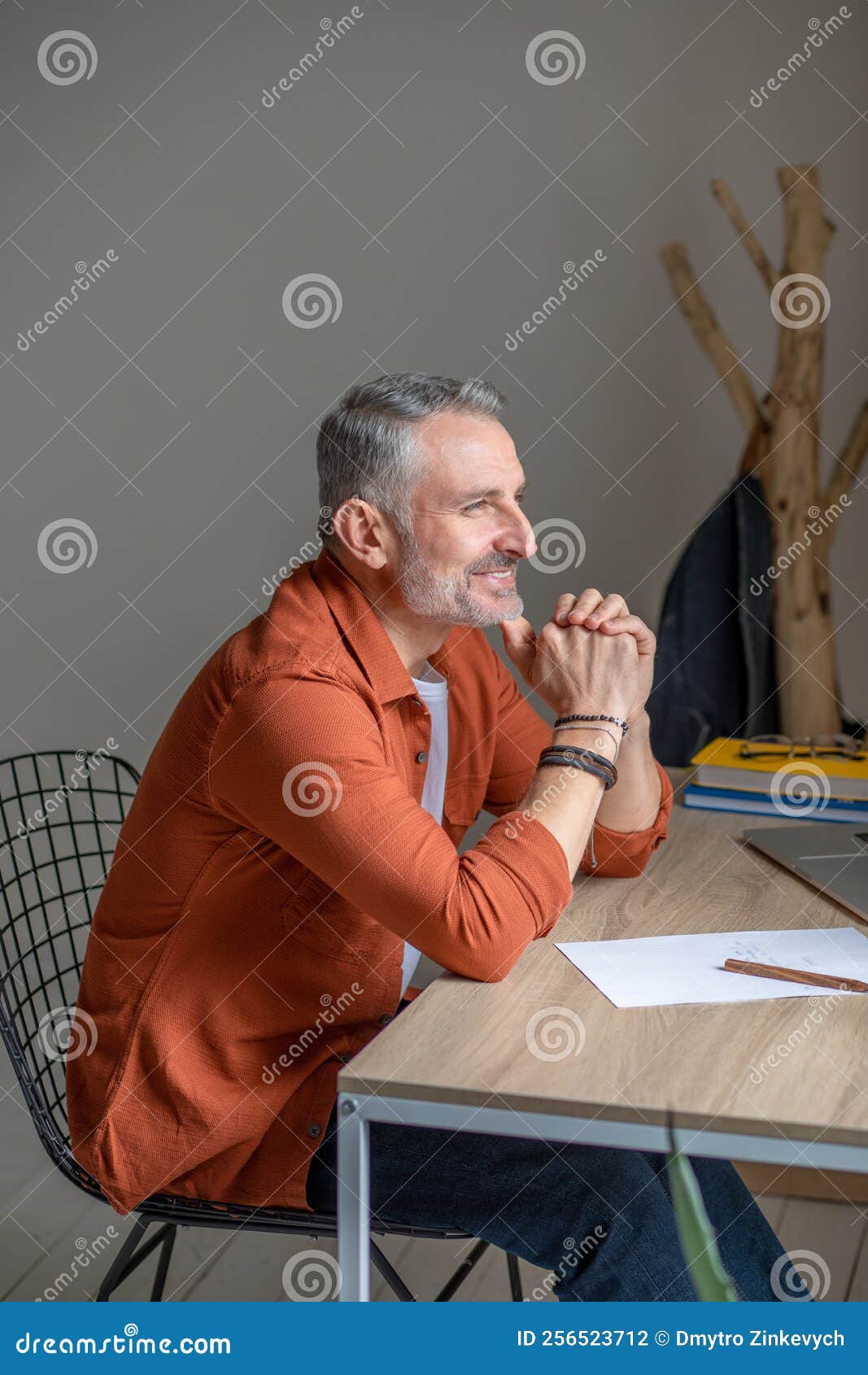 Manager Sitting at the Table in the Office and Looking Thoughtful Stock ...