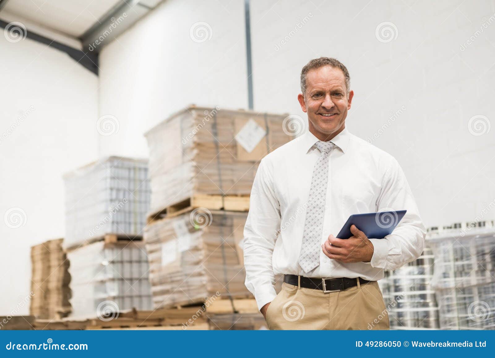 Manager Standing with Hand in the Pocket Holding Tablet Pc Stock Photo ...