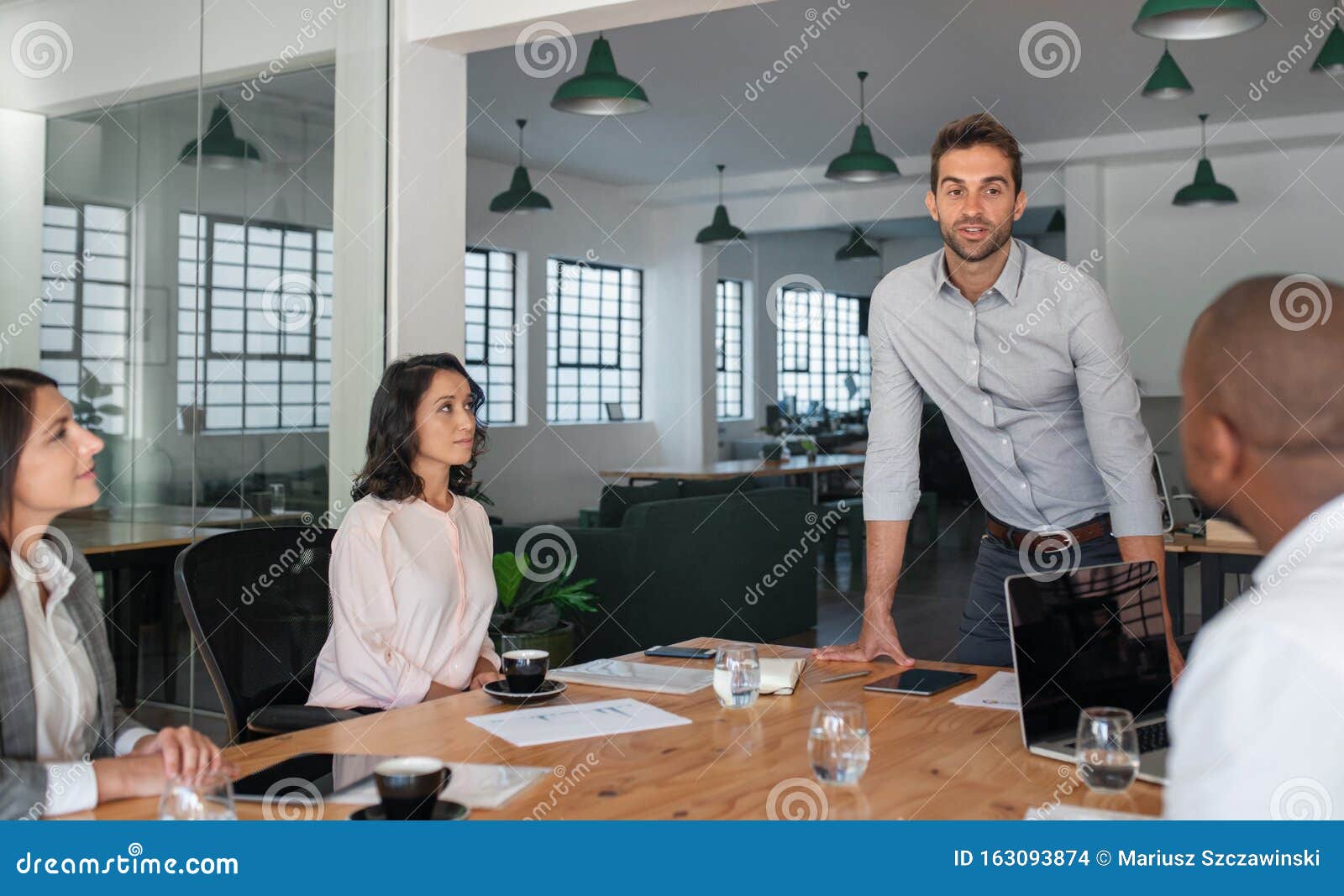 Manager Talking with His Staff Around an Office Table Stock Photo ...